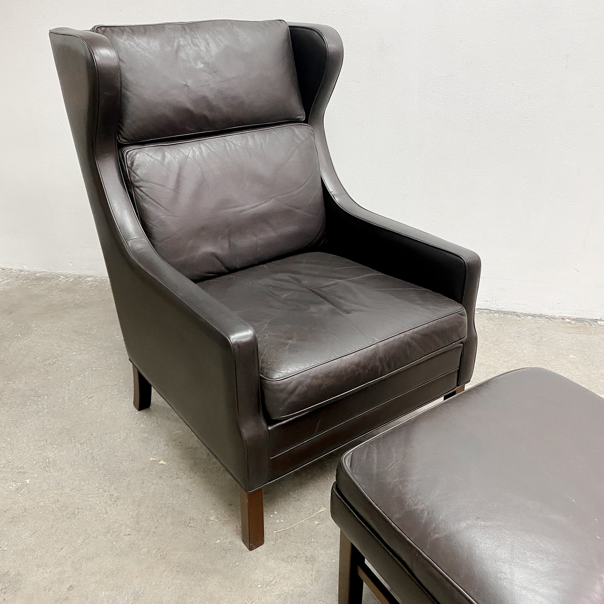 Danish Chocolate Leather Wingback Chair With Footstool– The Design Ark
